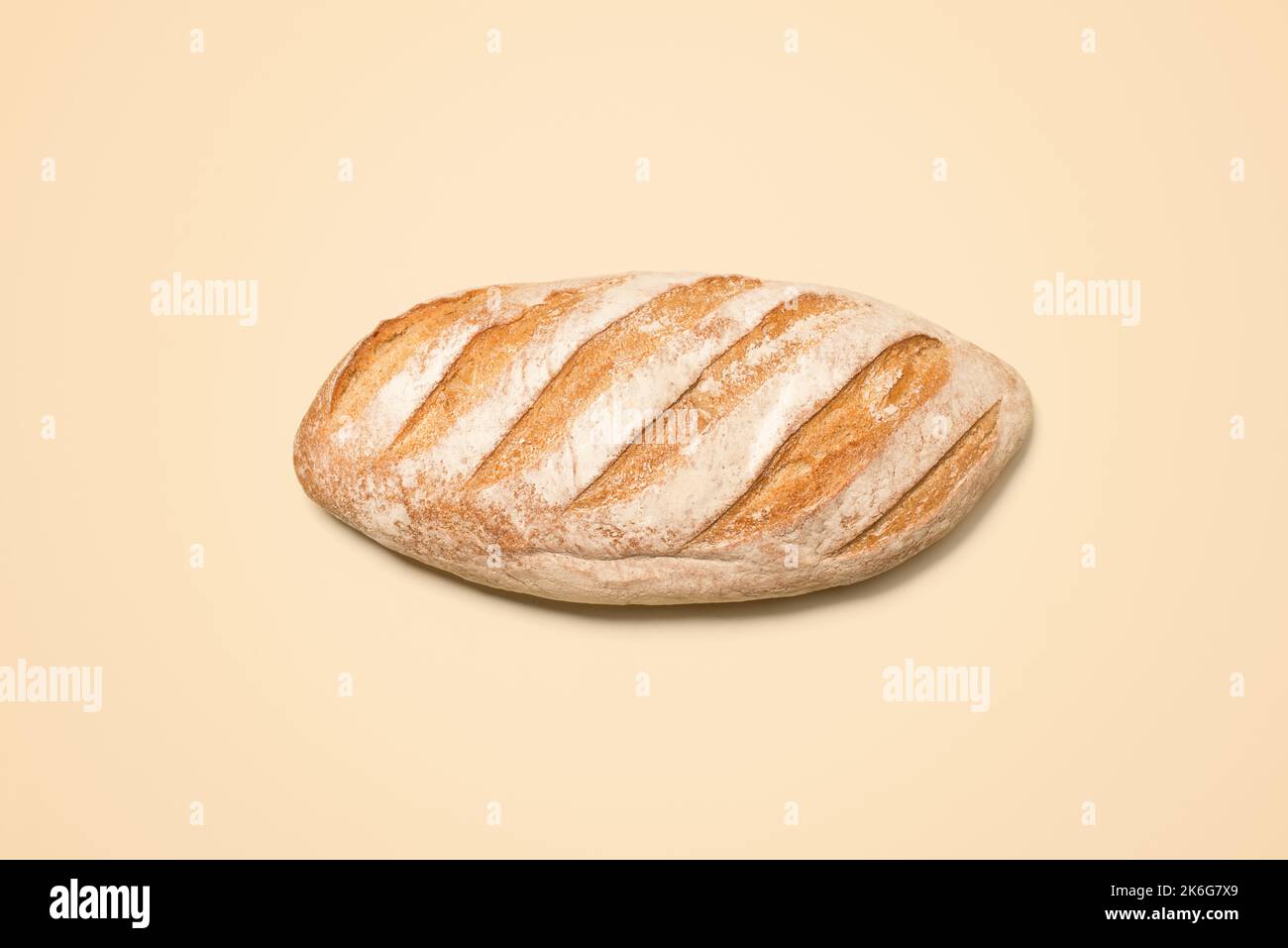 Ready for a brothy bowl of soup. a loaf of bread against a studio ...