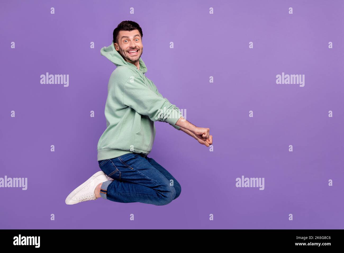 Full body photo of attractive young man toothy smile ride invisible ...