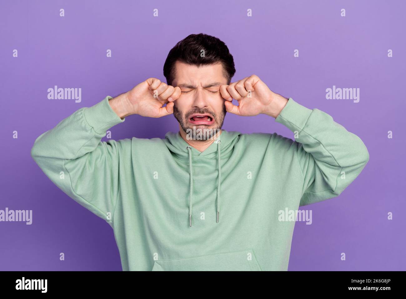 Photo of young unhappy funny cute man bearded brunet crying loud ...