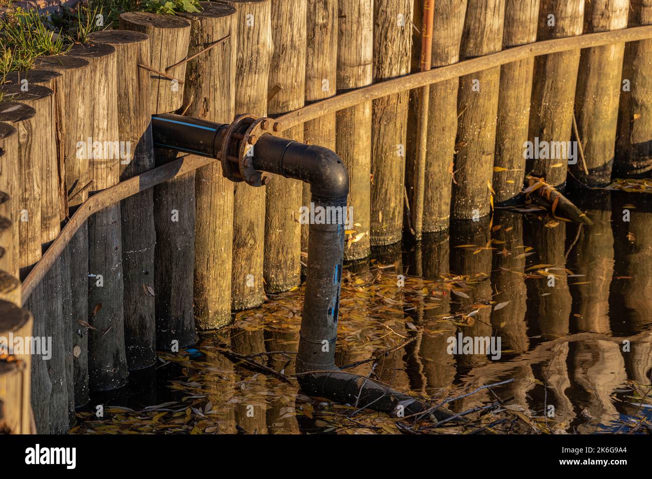 pipe from the pump immersed in a pond. water intake Stock Photo - Alamy