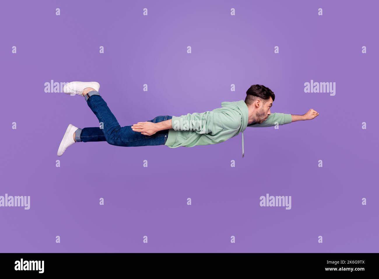 Full body photo of attractive young man flying superman fist confident ...