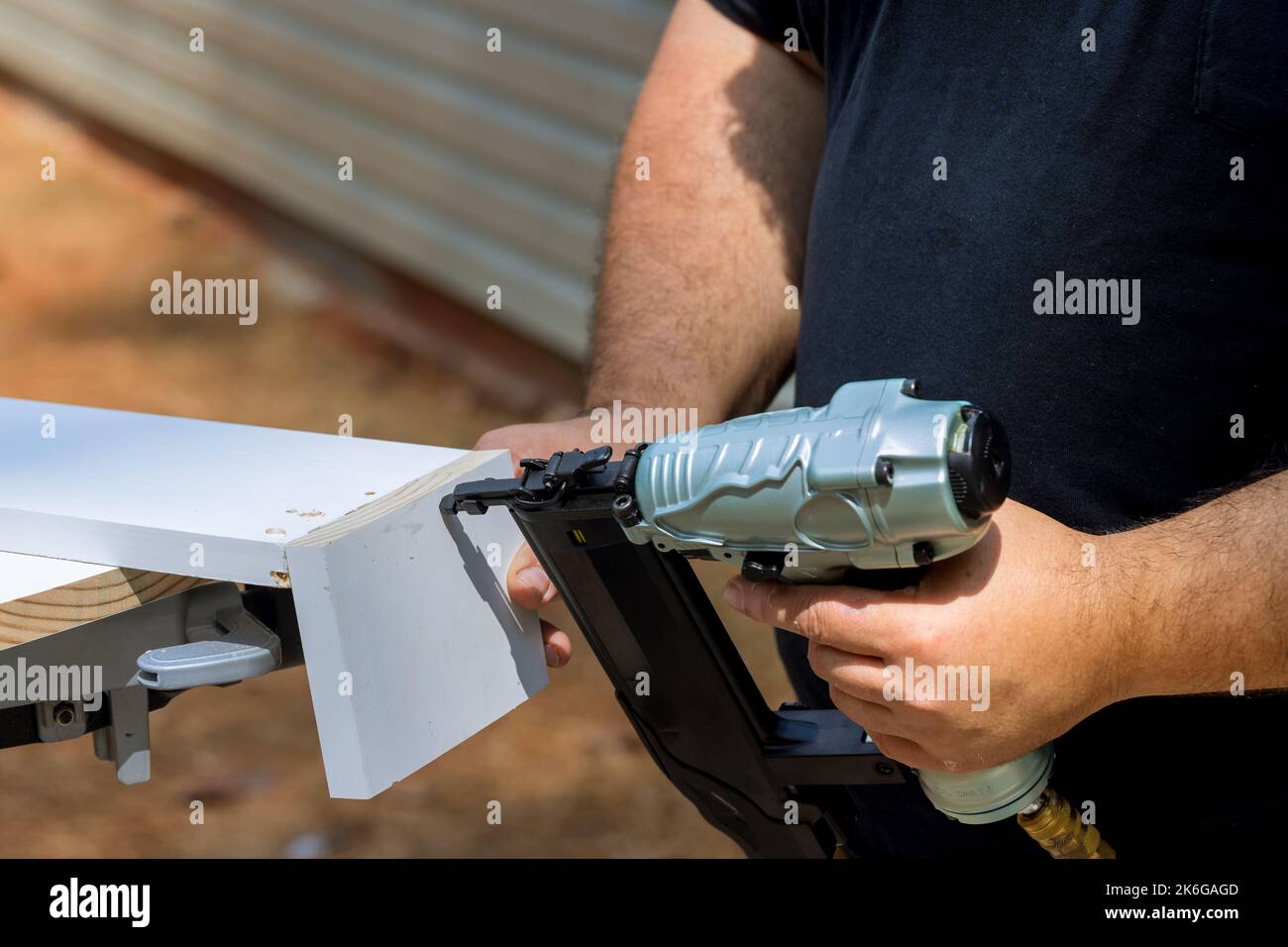 With help of pneumatic air gun carpenter connects assembly for wood ...