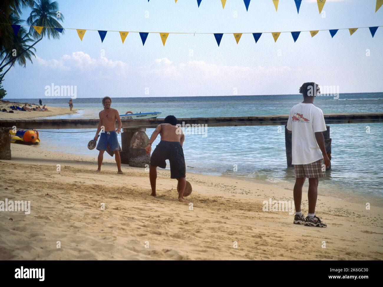 Pigeon Point Tobago Teenagers Playing With Bat & Ball Stock Photo - Alamy