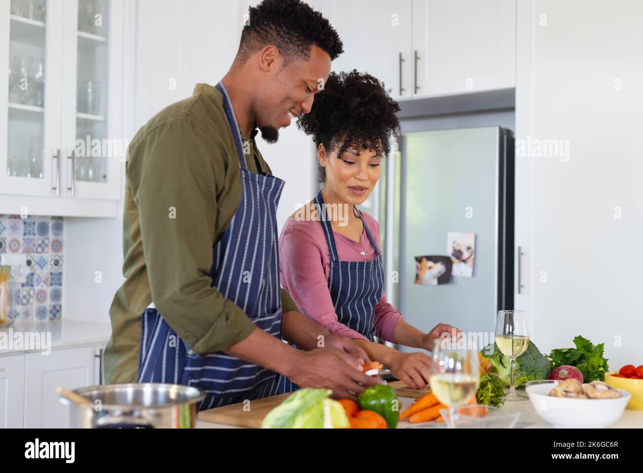 Happy african american couple cooking dinner together in kitchen Stock ...
