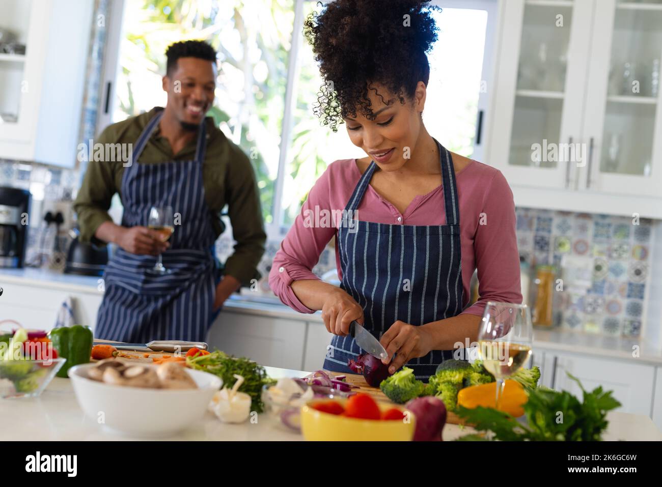 Happy african american couple cooking dinner together in kitchen Stock ...