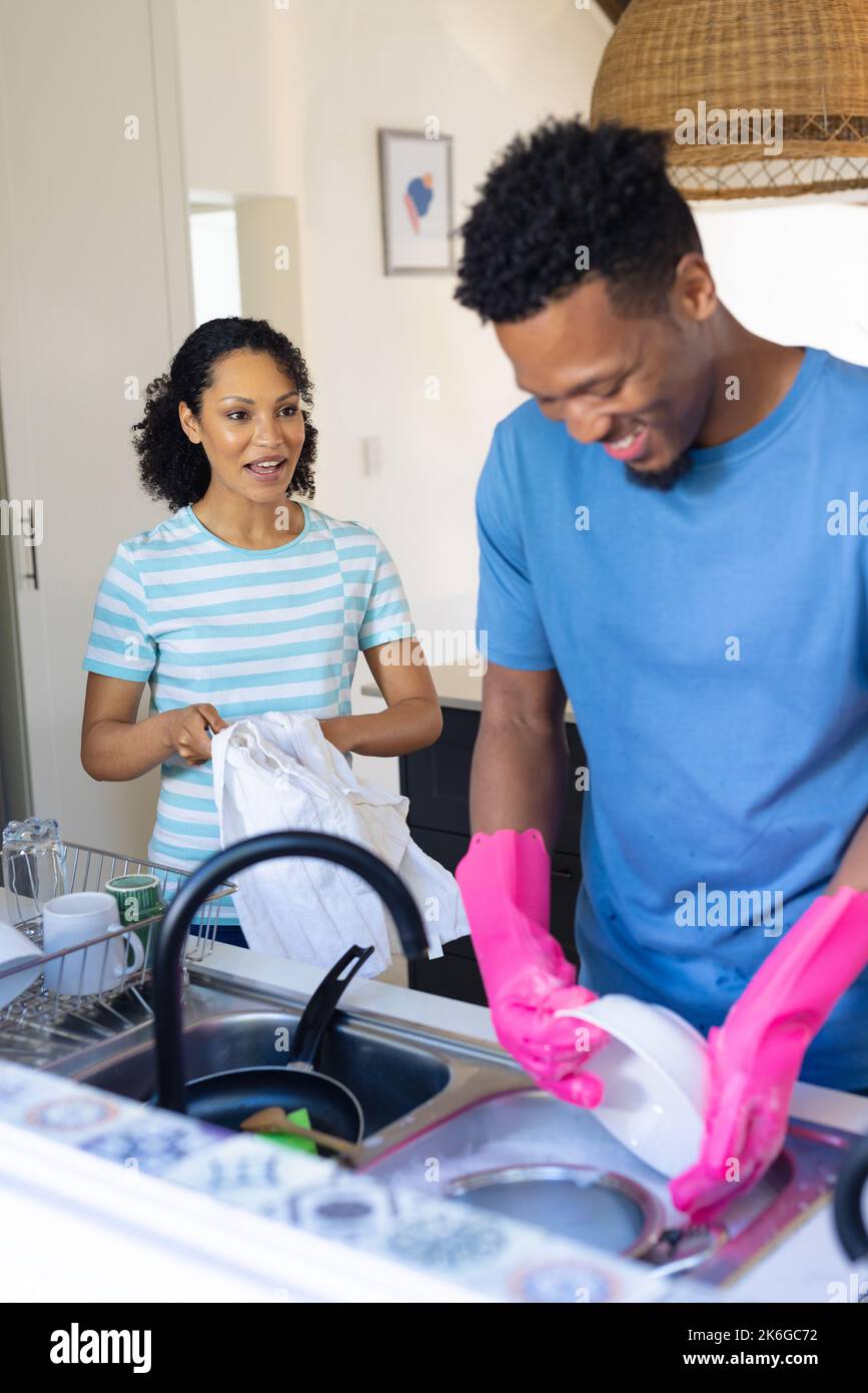 Happy african american couple washing dishes together in kitchen Stock ...