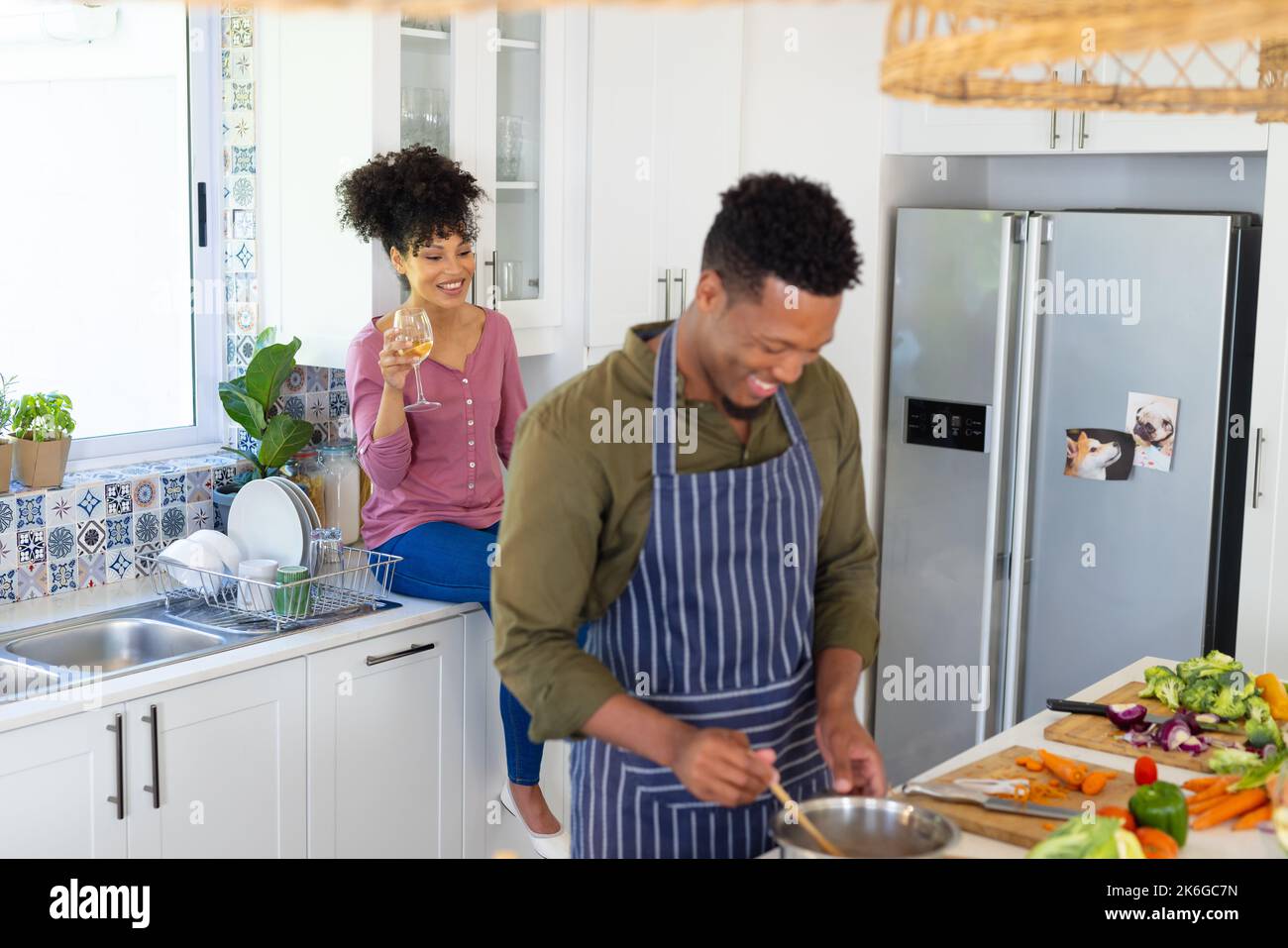 Happy african american couple cooking dinner together in kitchen Stock ...