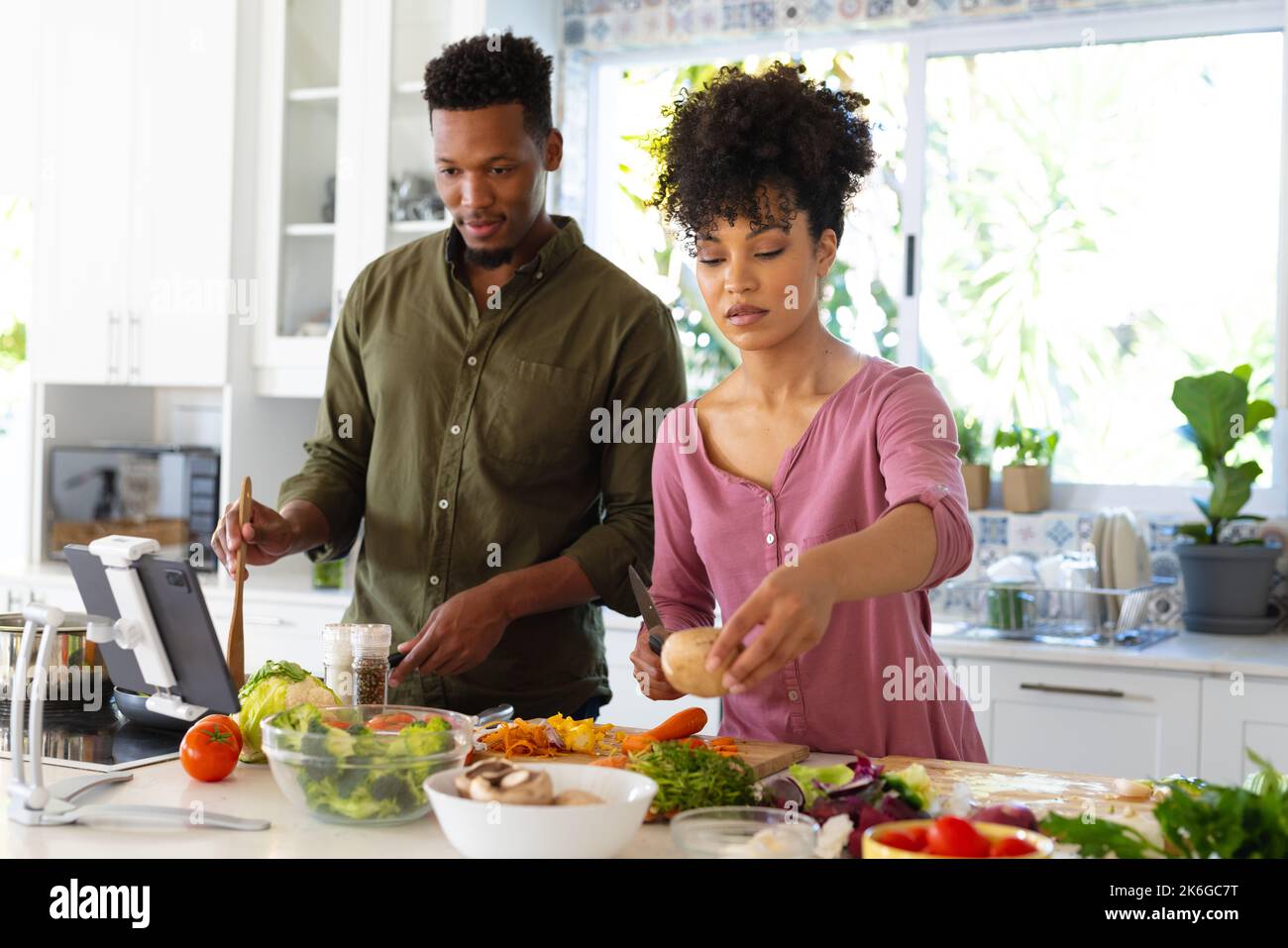 Happy african american couple cooking dinner together in kitchen Stock ...