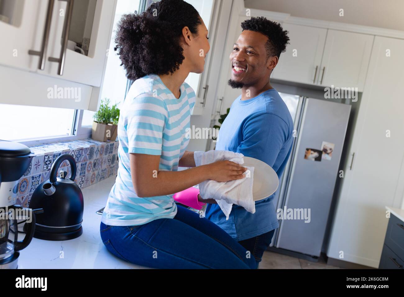 Happy african american couple washing dishes together in kitchen Stock ...