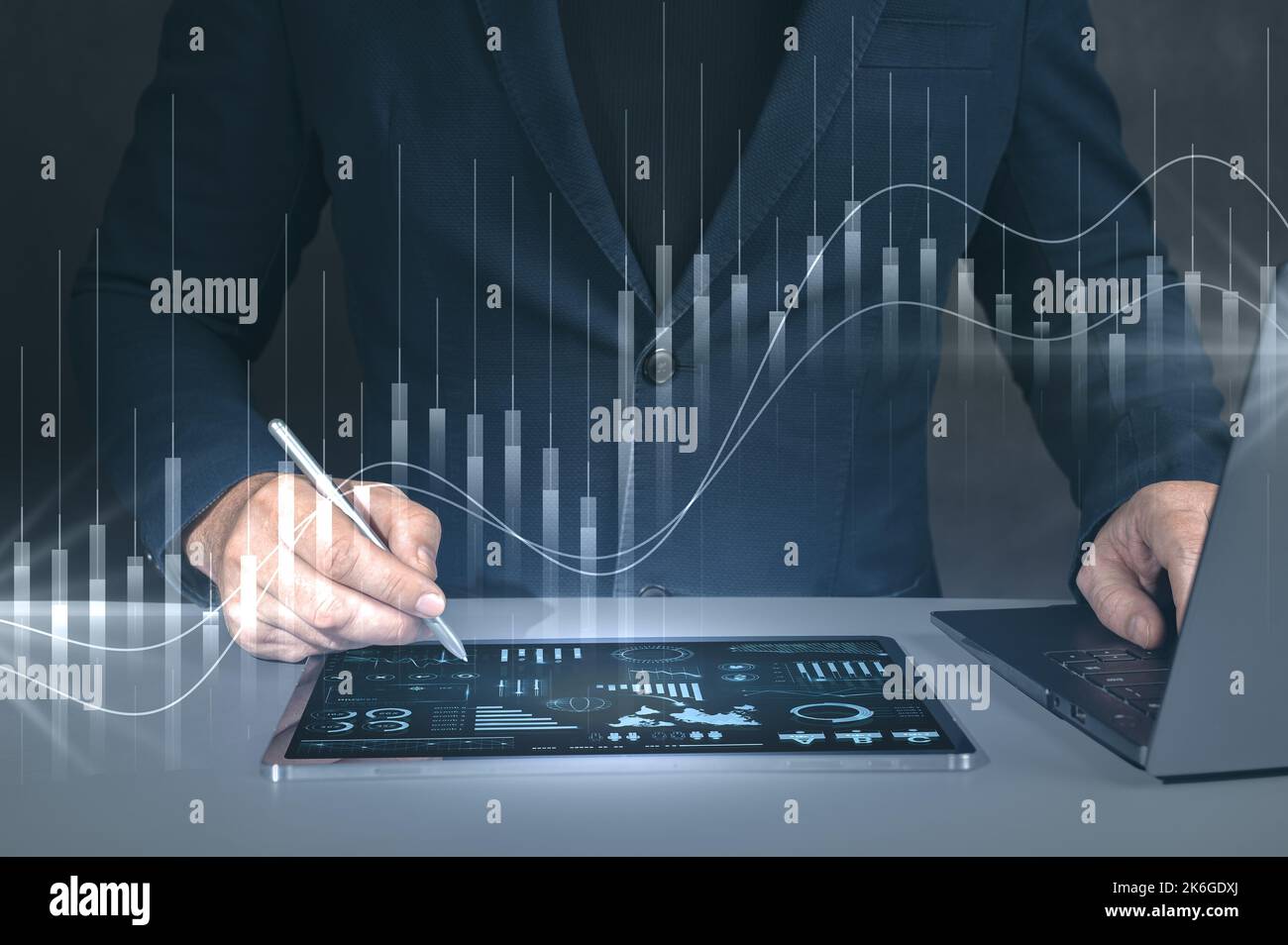 Businessman using tablet and laptop. digital diagram,graph interfaces ...
