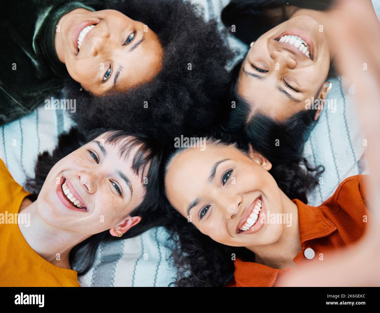 Friends are those rare people. female friends lying together on the ...