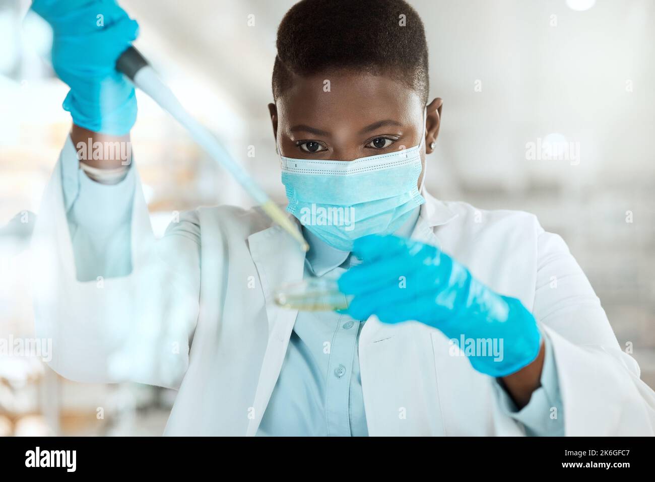 Lets see whats happening here. a young scientist sitting alone in her ...