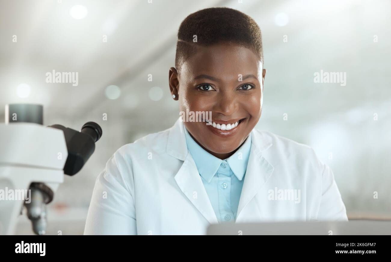 Lets find a cure. an attractive young scientist sitting alone in her ...