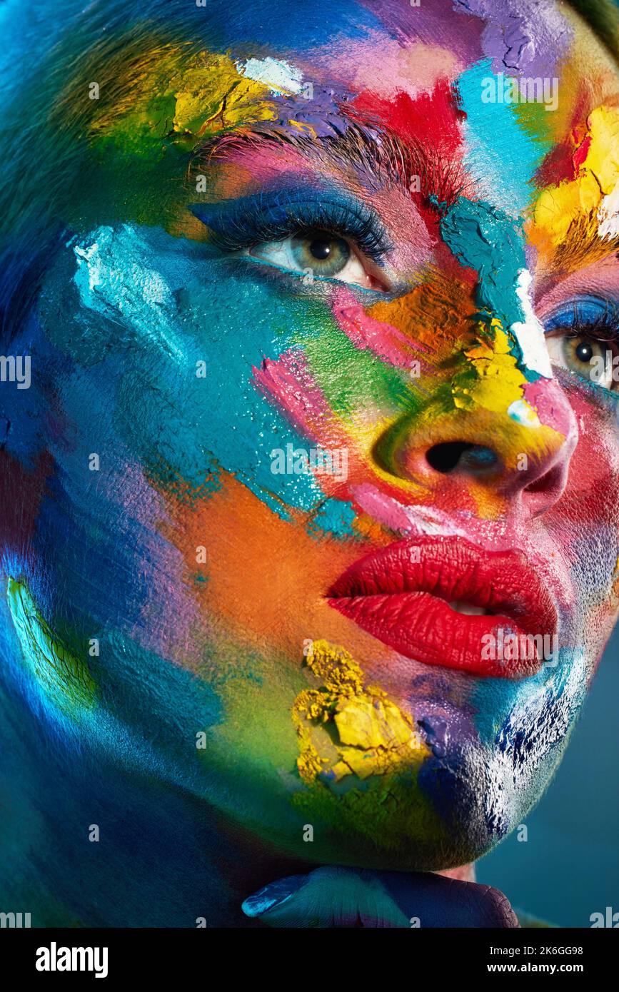 Try to be a rainbow in someones cloud. Studio shot of a young woman ...