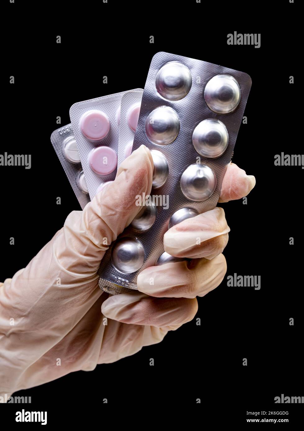Medical pills in blister on isolated black background with reflection ...