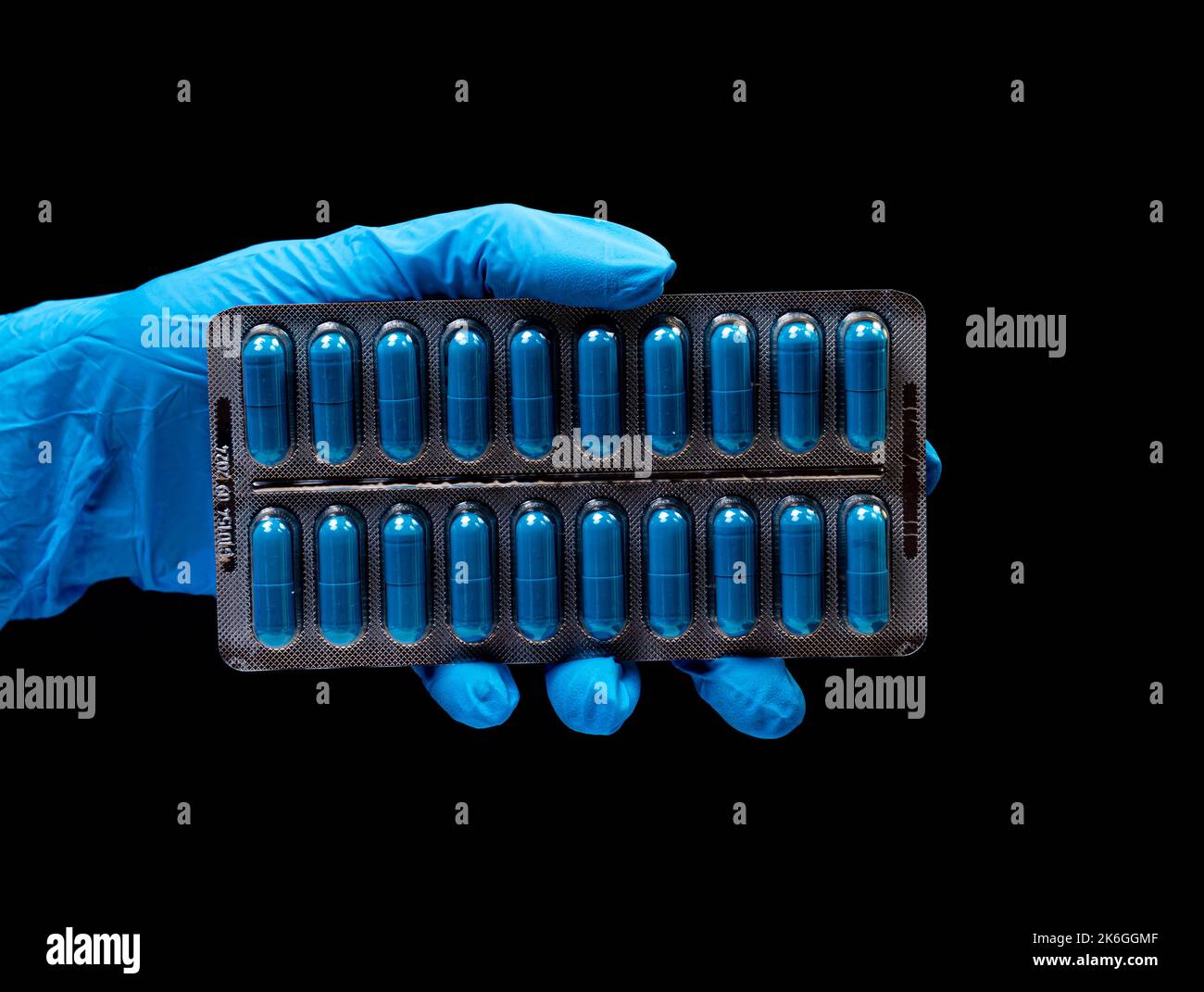 Medical pills in blister on isolated black background with reflection ...