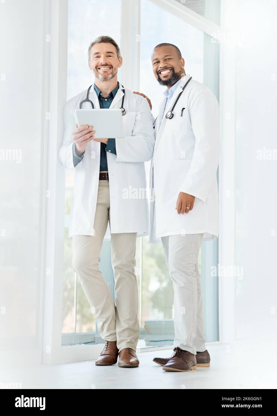 Coming together as the top in their field. two mature doctors using a ...