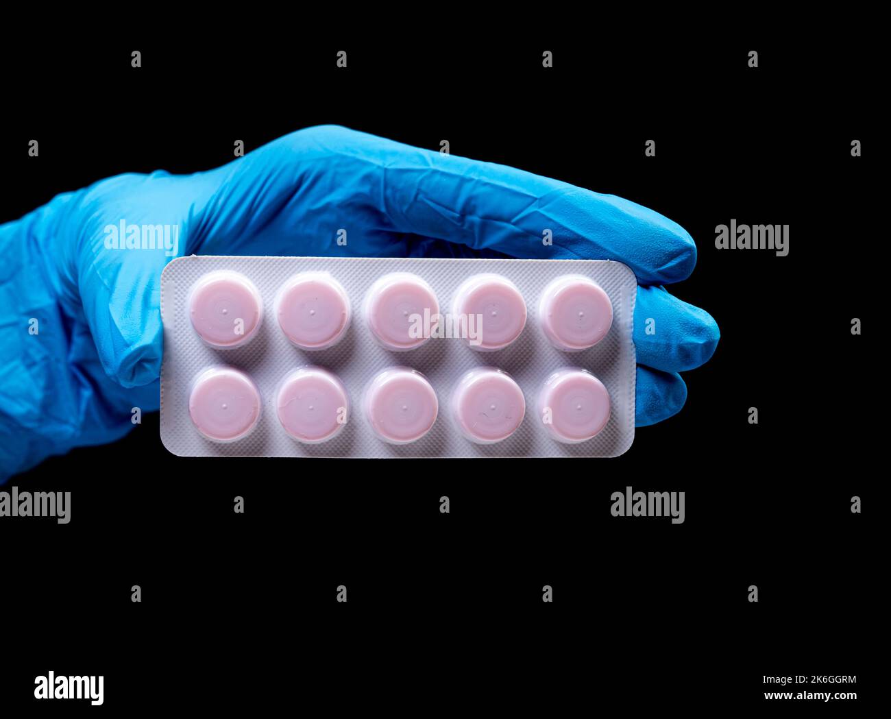 Medical pills in blister on isolated black background with reflection ...