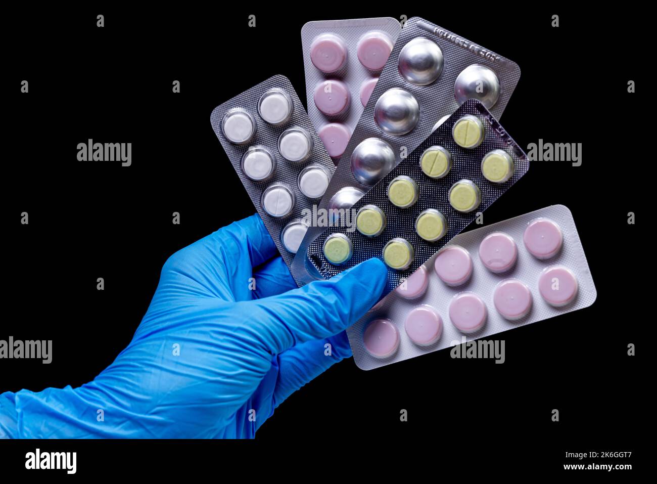 Medical pills in blister on isolated black background with reflection ...