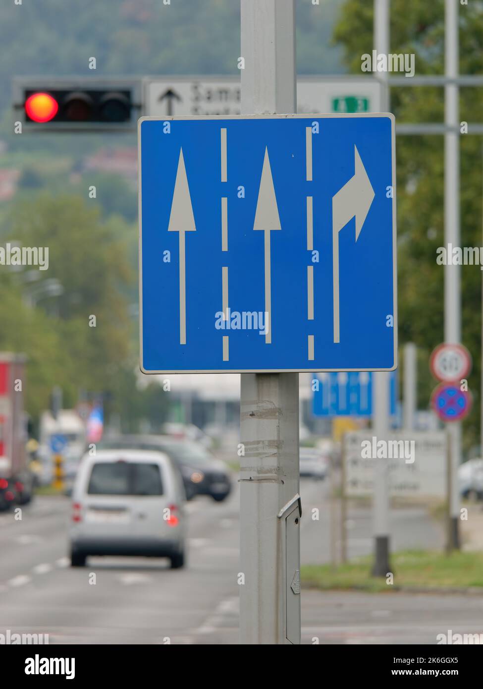 A selective focus of road lane and direction sign on background of the ...