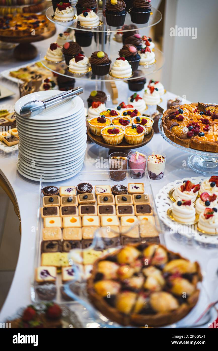 Delicious wedding reception candy bar dessert table with various sweets ...