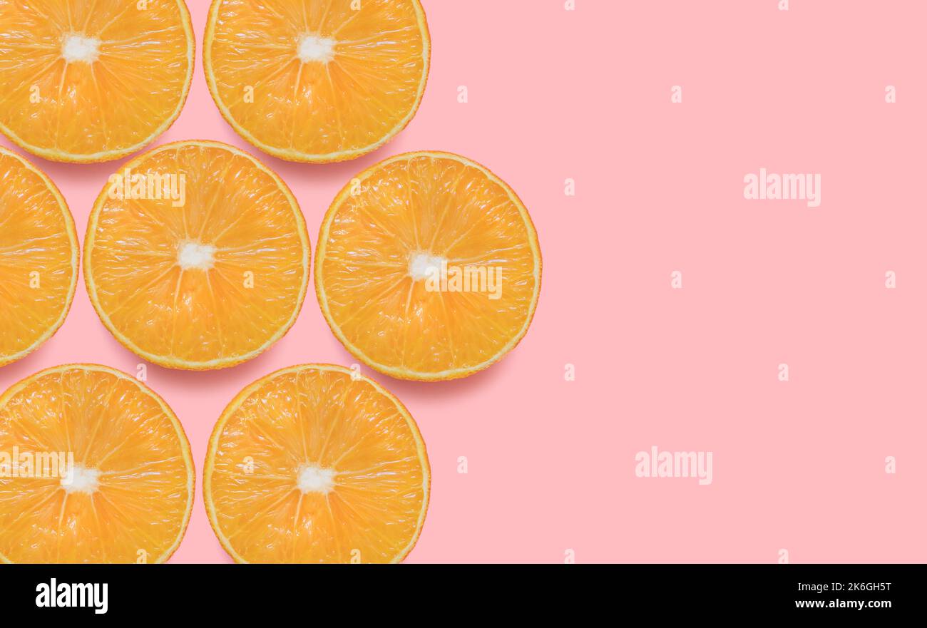 Ripe citrus fruits. Halves of oranges on pink background. Top view ...