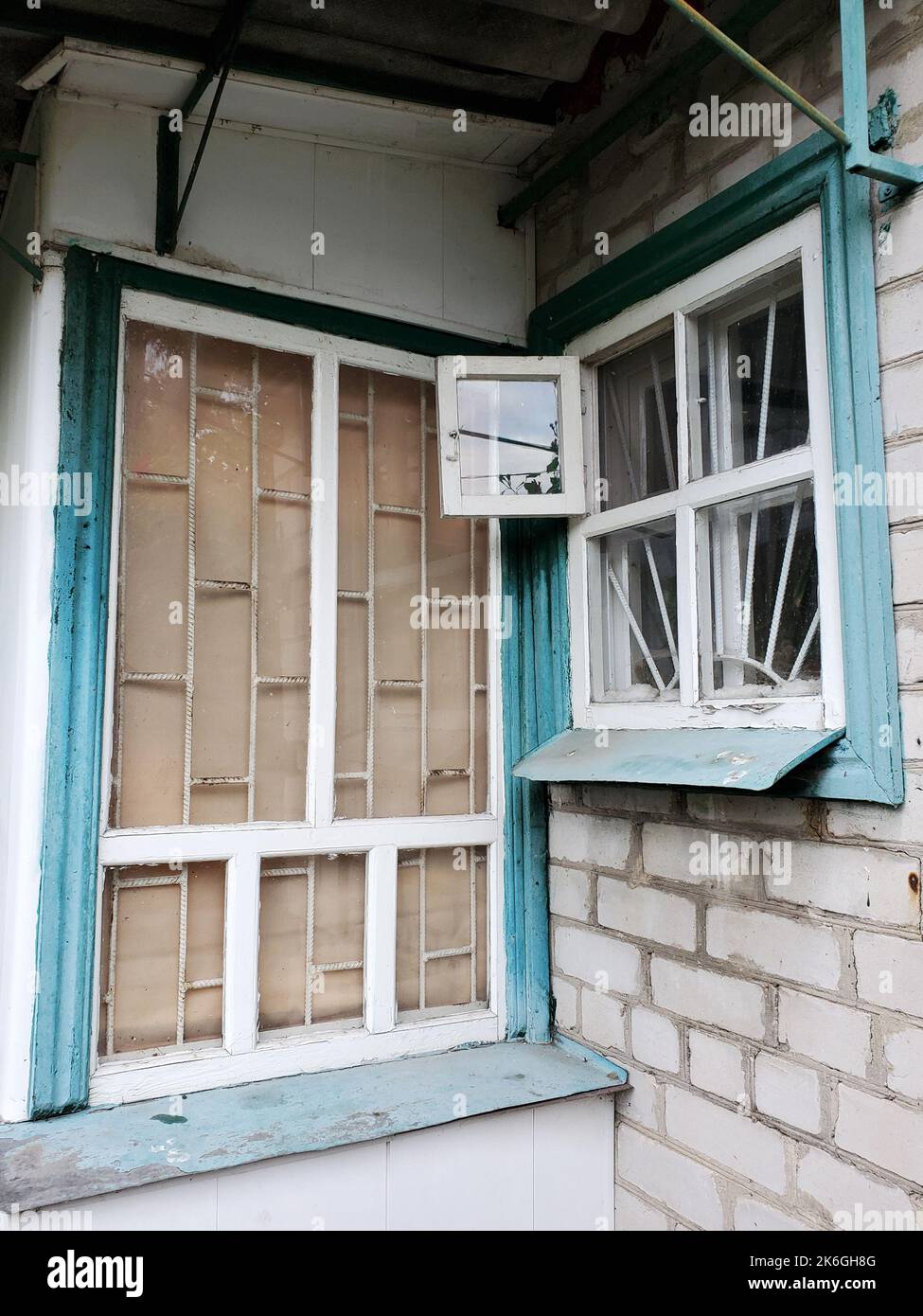 Old brick house with bars on the windows to protect against thieves ...