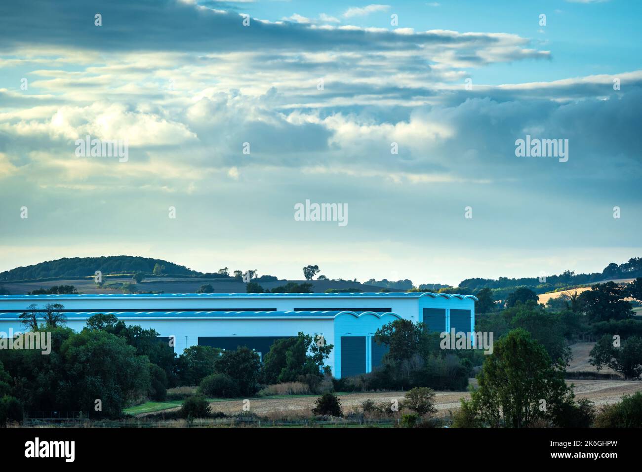 new built distribution warehouse building with farm fields in ...