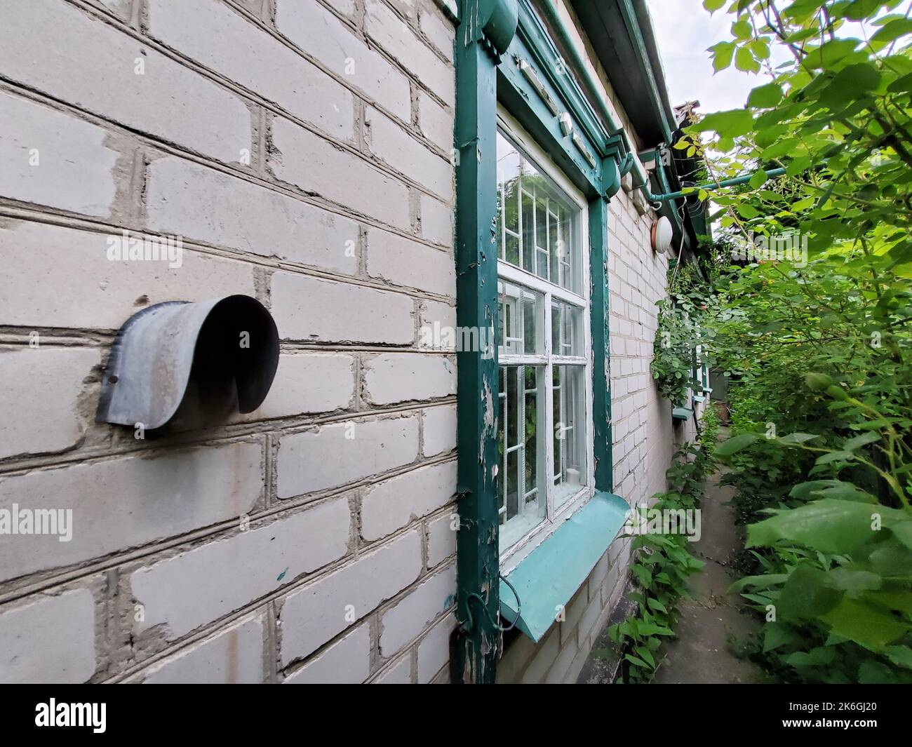 Old brick house with bars on the windows to protect against thieves ...