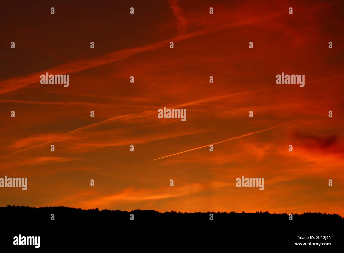 A low angle shot of a bright orange red sunset sky over a field Stock ...