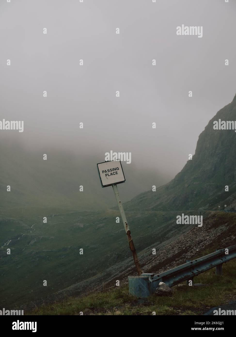 A passing place highland mountain narrow road sign shrouded in low ...