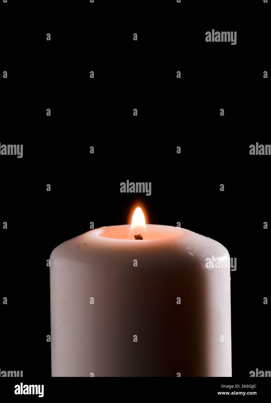 Wax candle with a dark back flame Stock Photo - Alamy