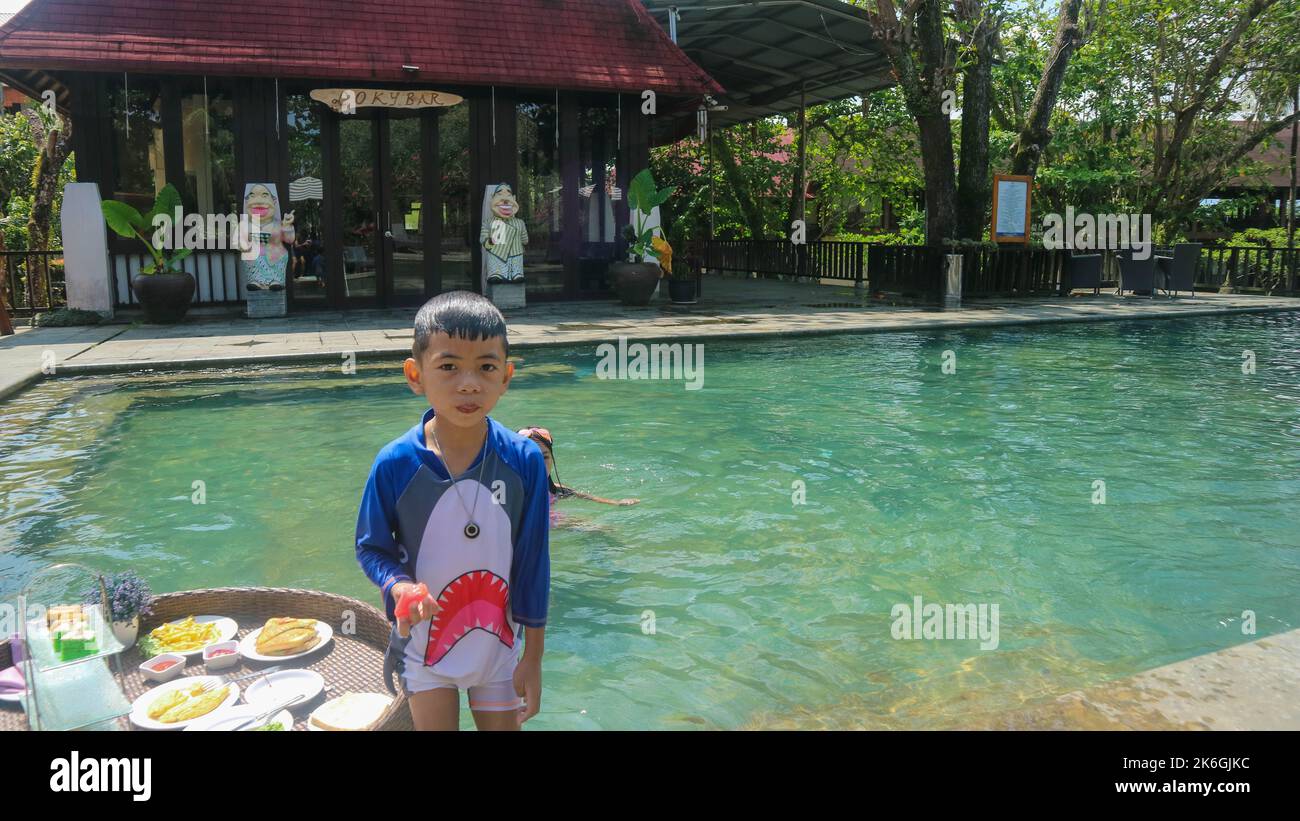 an adorable boy having breakfast floating in the pool Stock Photo - Alamy