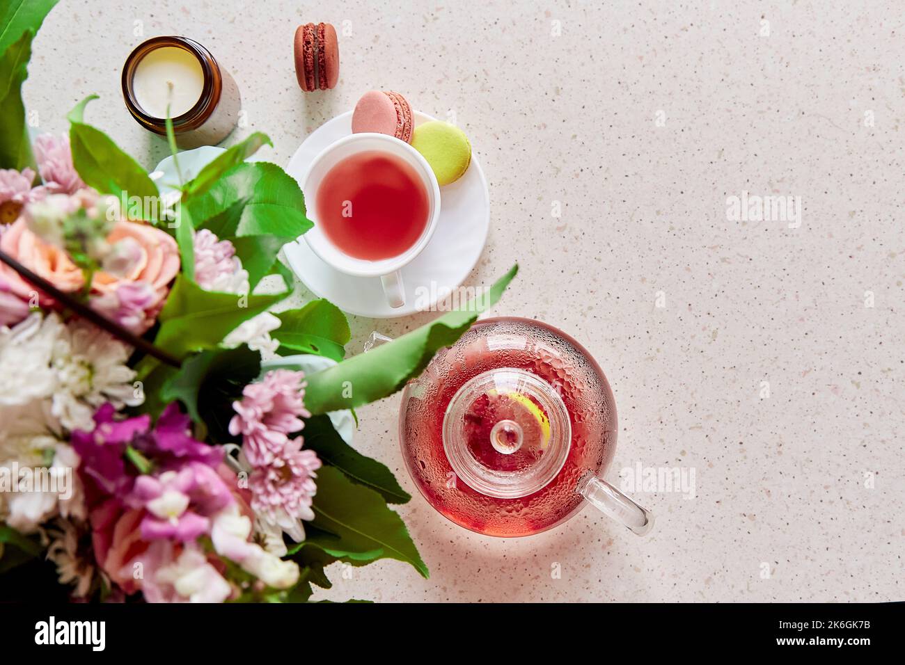 Healthy raspberry natural tea glass teapot, macarons, candle and ...