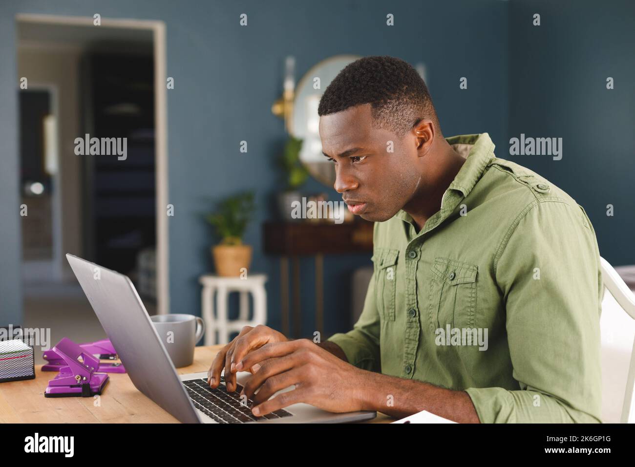 African american man working at home in bedroom using laptop and concentrating Stock Photo - Alamy