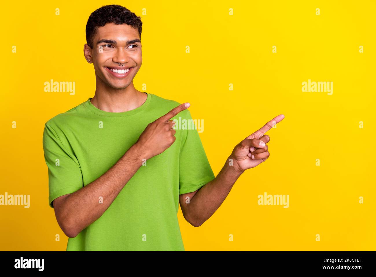 Photo portrait of handsome young man point look empty space shopping ...