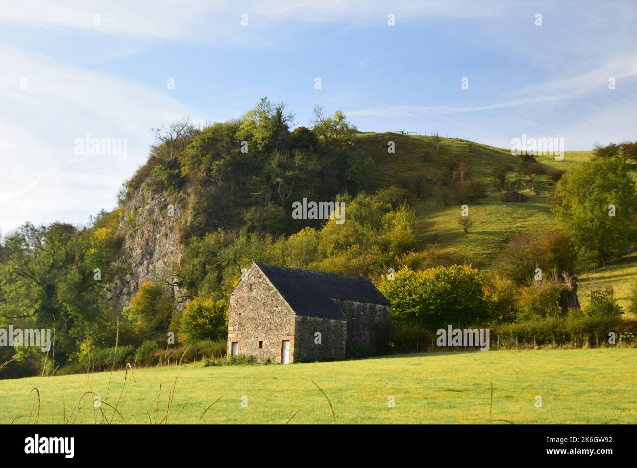 The wooded hillsides and limestone pinnacles along the Manifold valley ...