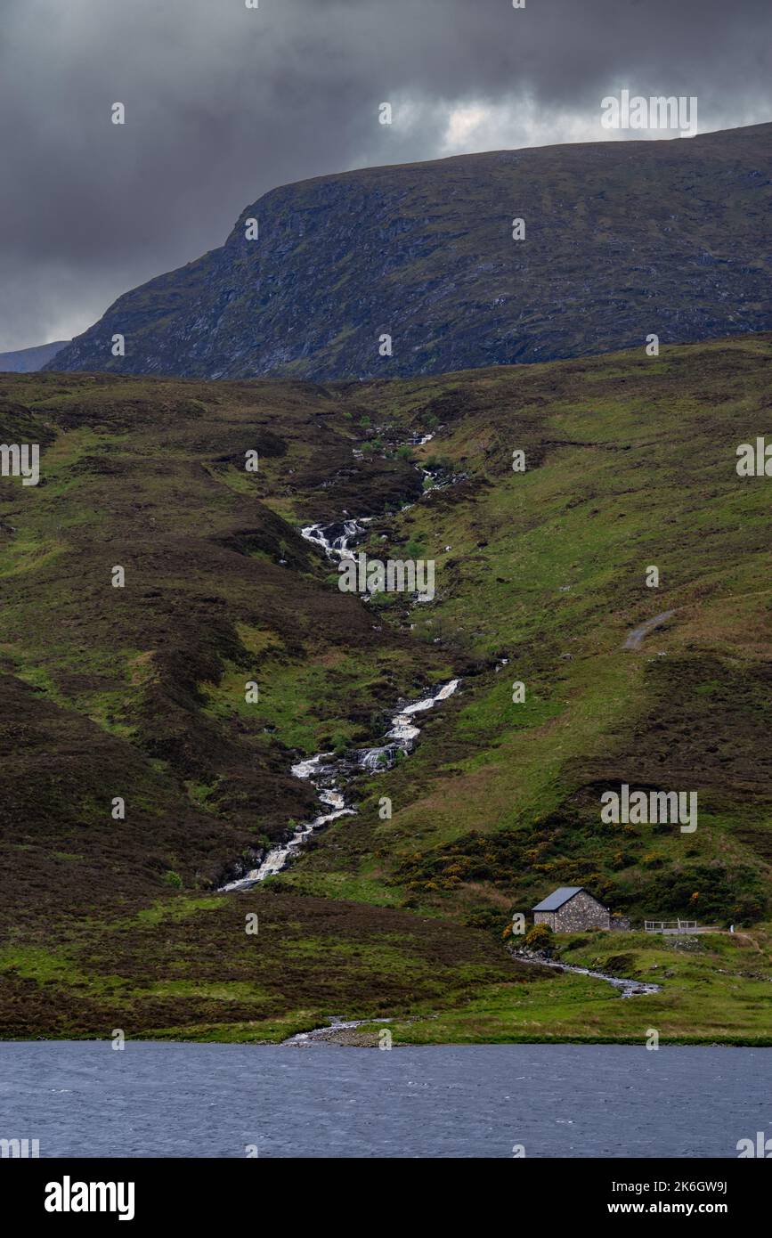 A vertical view of a thrust fault with a mountain in the background ...