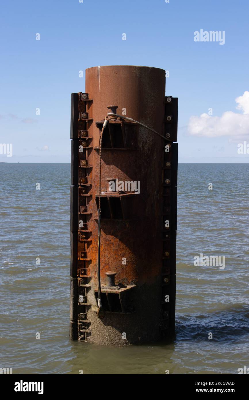 Rusty metal dolphin or mooring post in a harbor Stock Photo - Alamy