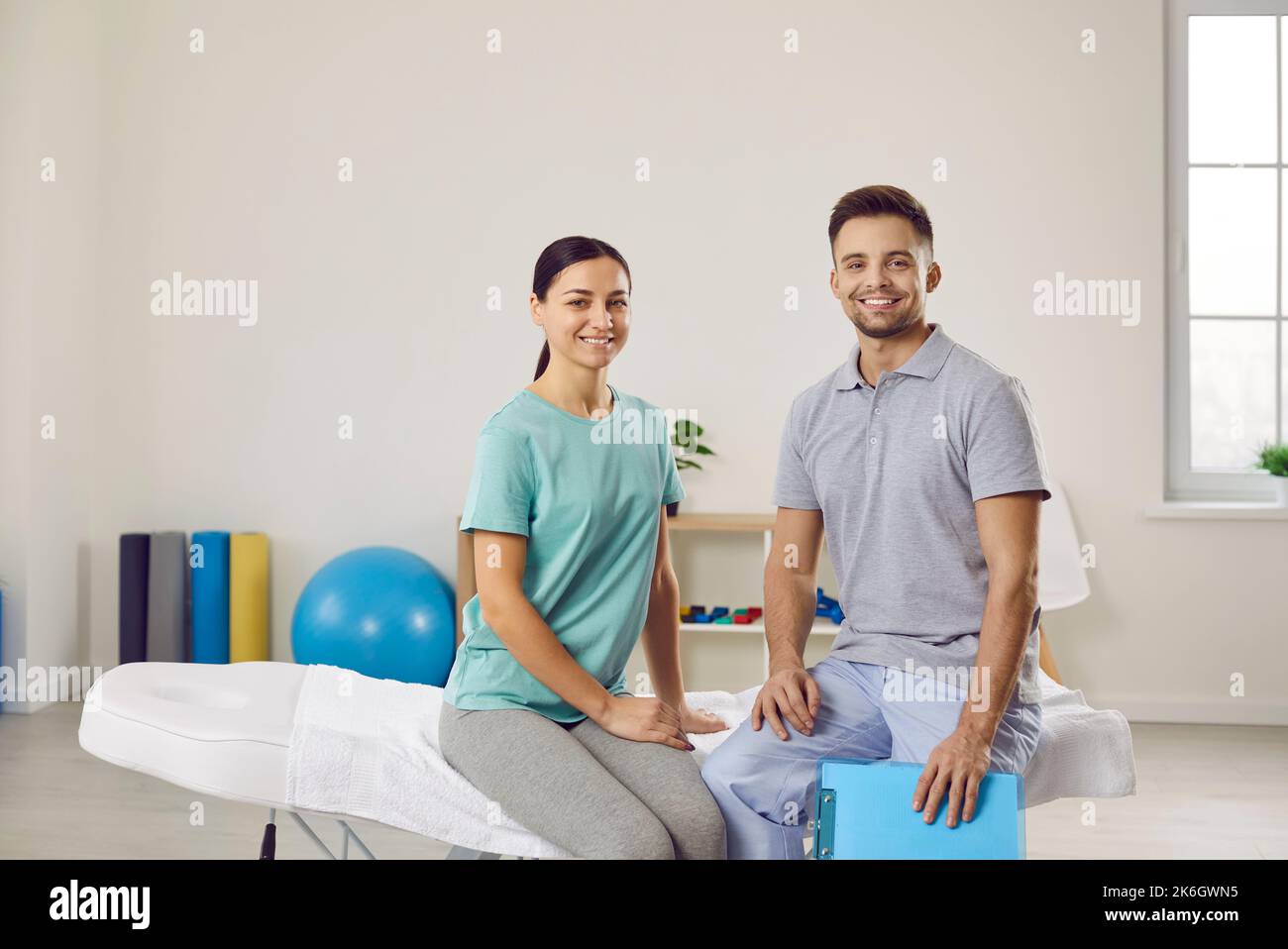 Portrait of happy patient with professional chiropractor, osteopath ...
