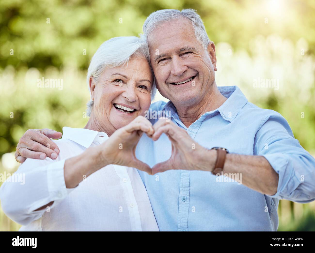 This is what love looks like. a senior couple forming a heart shape ...
