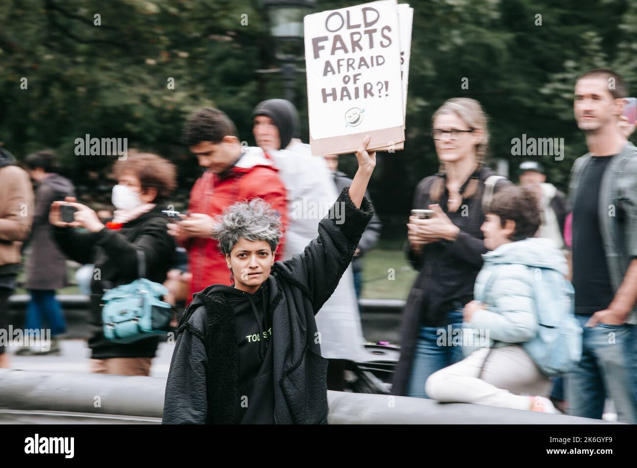 New York, United States. 01st Oct, 2022. Woman with short hair holds up ...