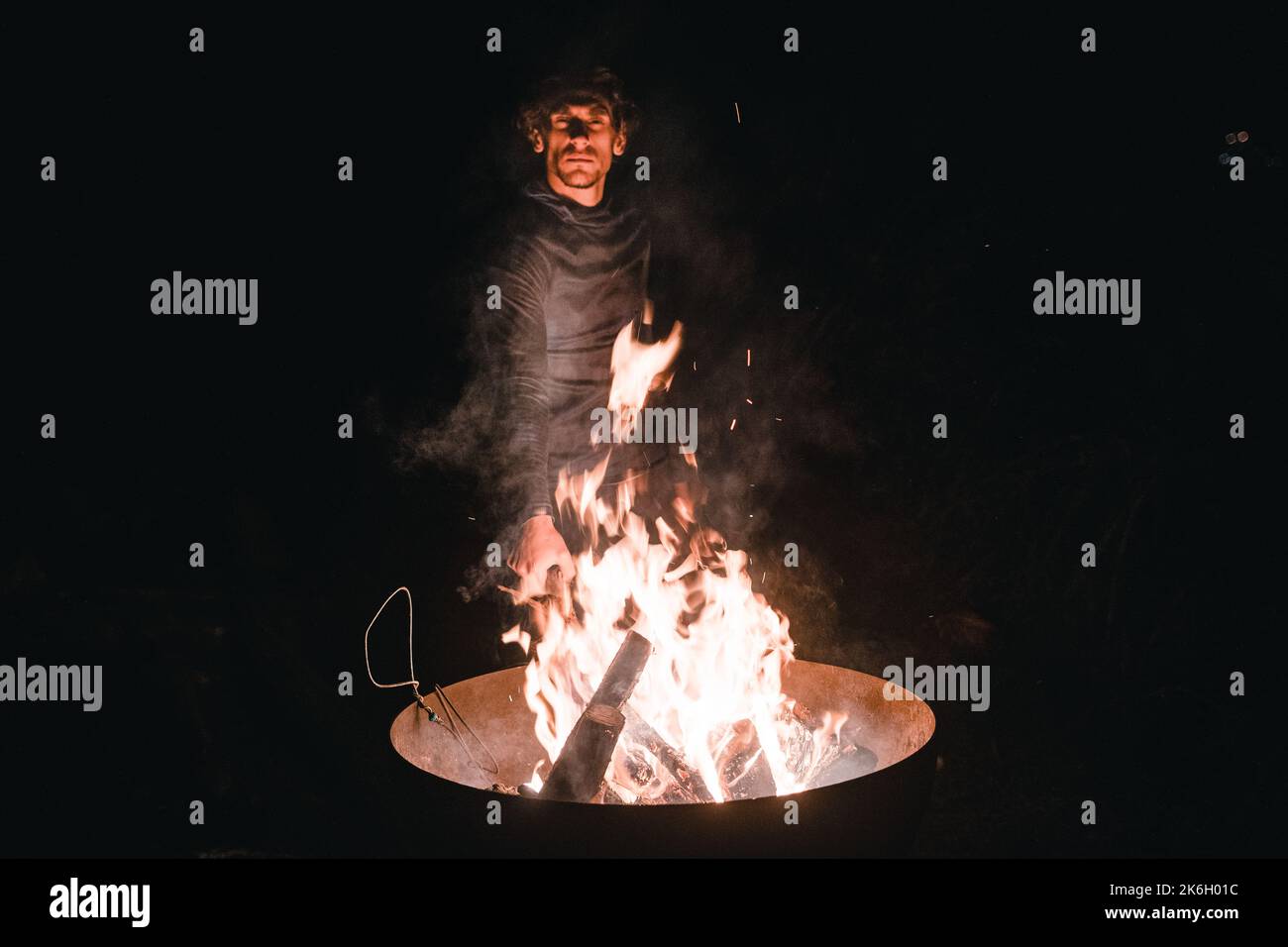 Man stoking fire hi-res stock photography and images - Alamy