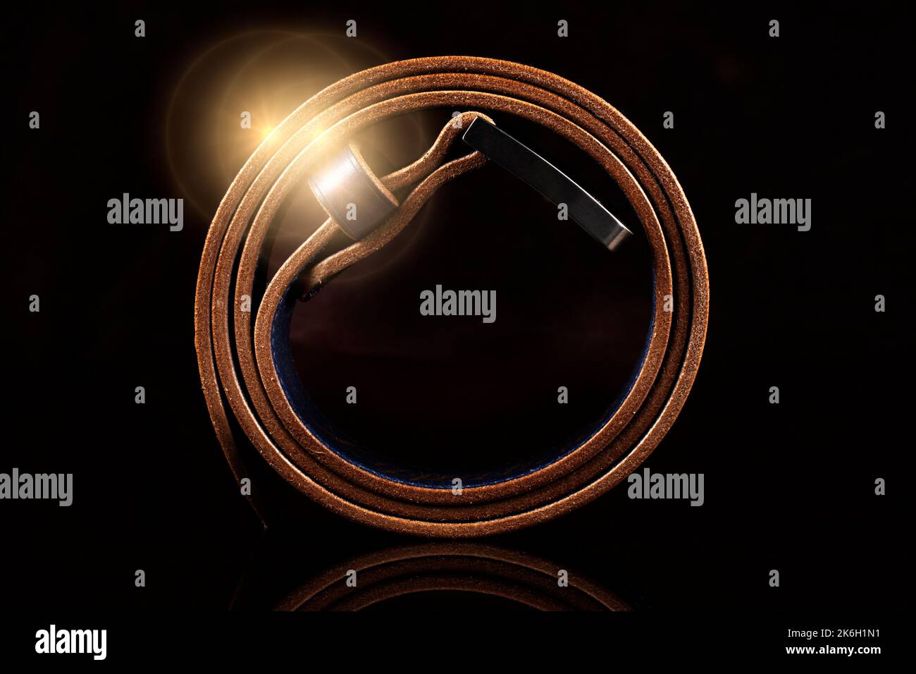 Leather brown belt on a dark background with reflection Stock Photo - Alamy