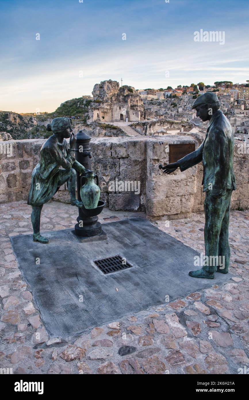 View of Matera behind the group of the bronze statues "Falling in love ...