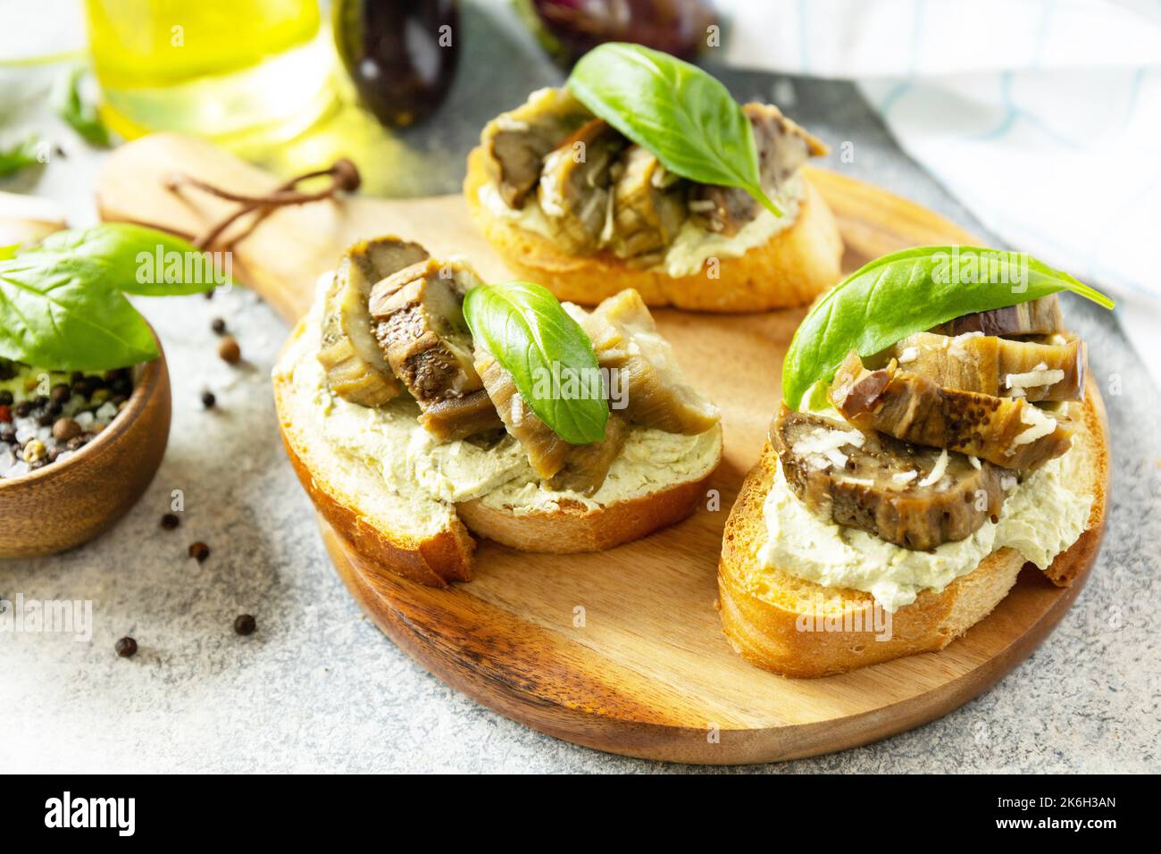 Open sandwiches set with grill aubergine and cream cheese on a stone ...