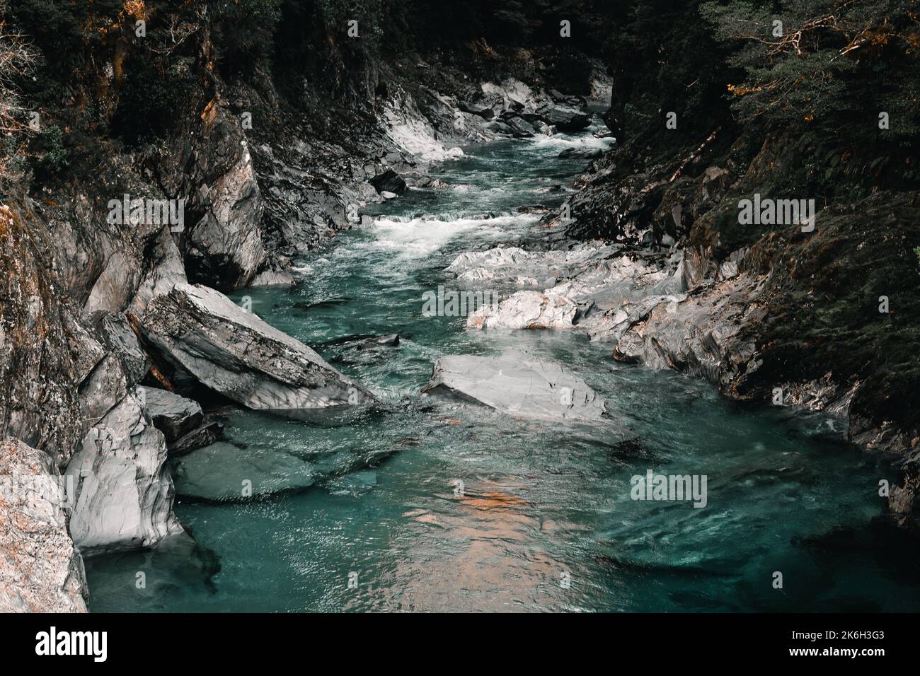 clean and transparent water flowing down the mighty river surrounded by ...