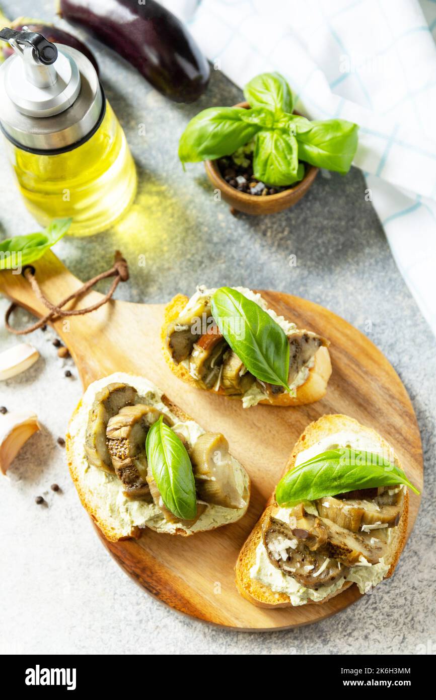 Open sandwiches set with grill aubergine and cream cheese on a stone ...
