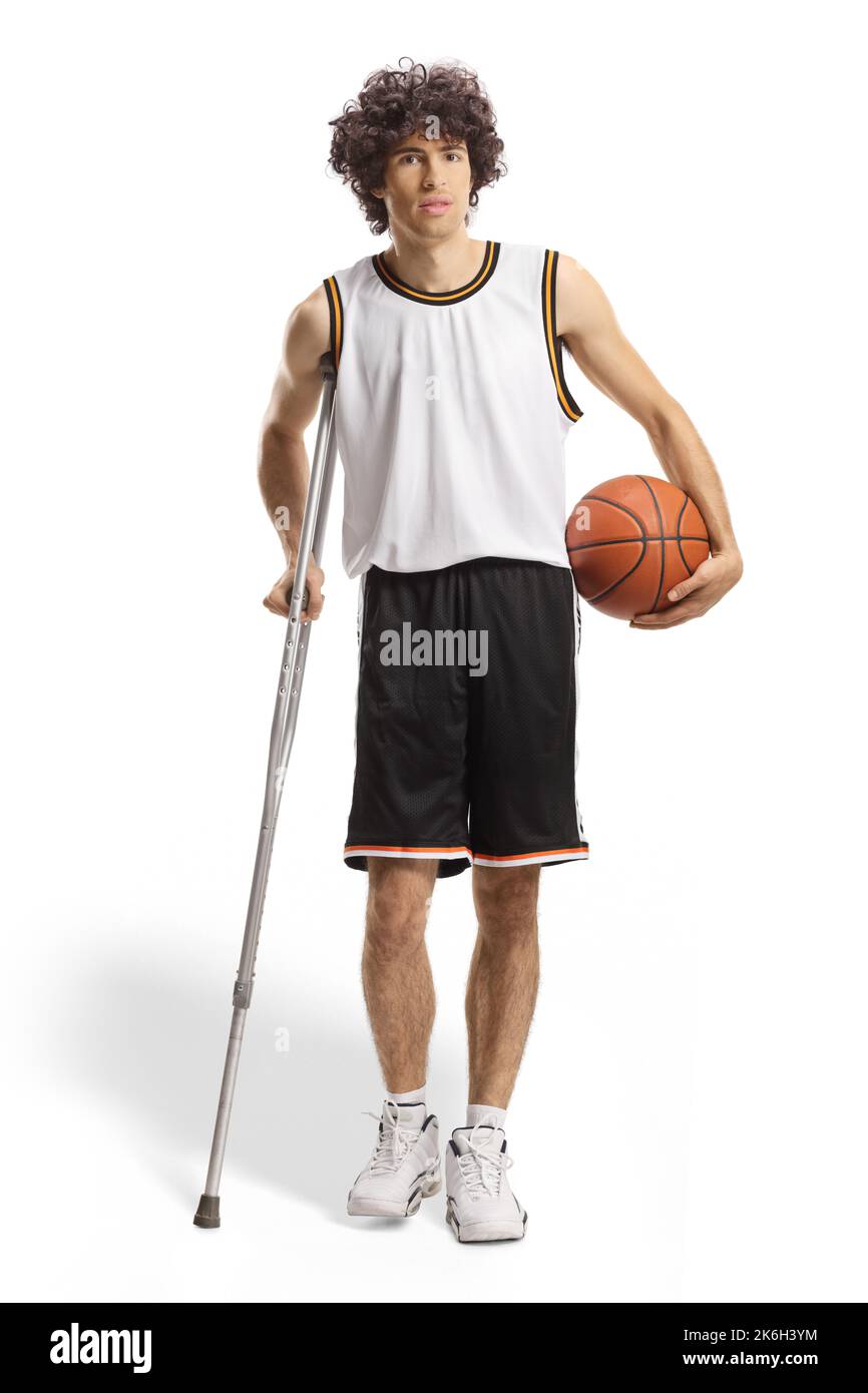 Basketball player holding a ball and walking with a crutch isolated on ...