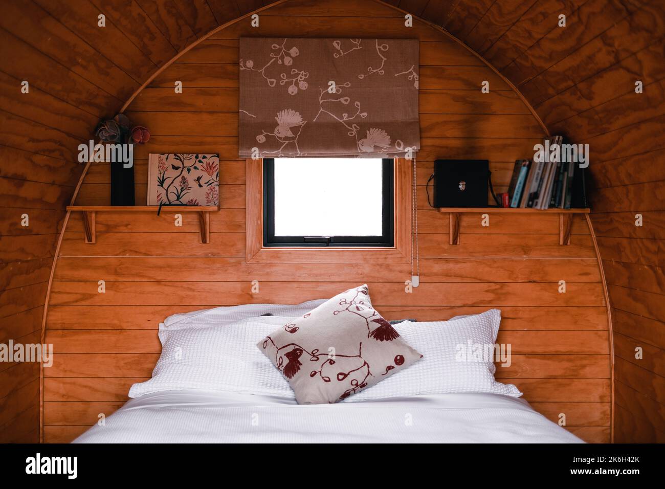 interior of nice room in log cabin with small bright window covered ...
